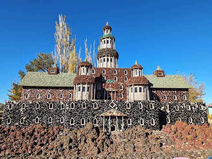 This elaborate rock mansion looks like a European castle had a baby with a geology textbook, and honestly, we're here for it.