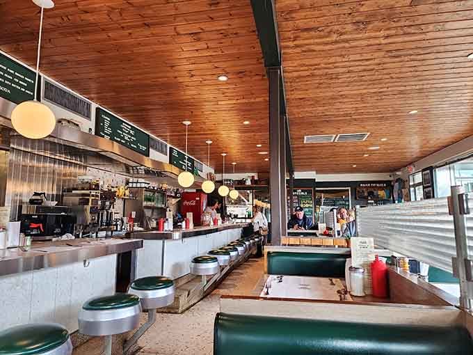 Warm wood ceilings, vintage counter stools, and pendant lights create the perfect blend of nostalgia and modern comfort.