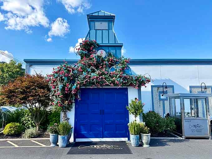 That vibrant blue door adorned with flowers isn't just an entrance, it's a promise of good things ahead.