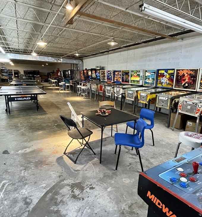 That industrial-chic vibe meets retro gaming paradise in a space that understands priorities perfectly.