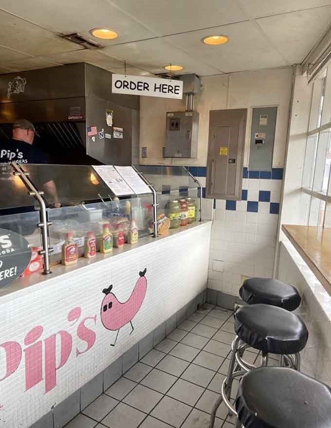 The cheerful pink pig logo and simple counter setup prove that great food doesn't need fancy surroundings to shine.