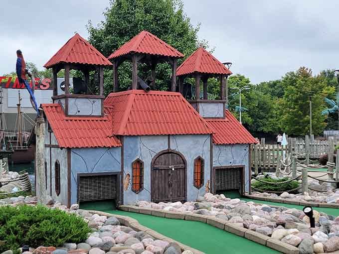 Those red-roofed towers aren't just for show, they're your backdrop for conquering eighteen holes of pure fun.