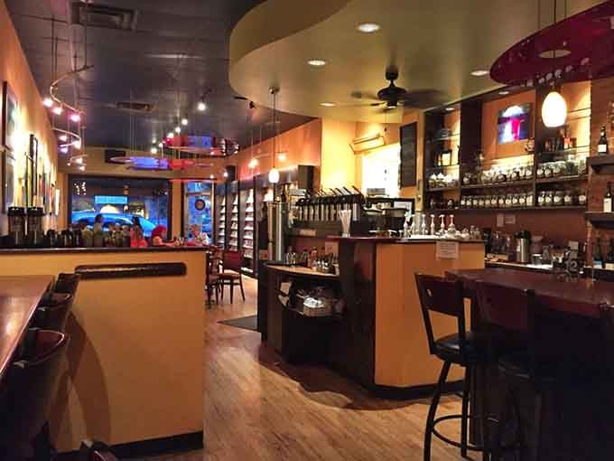 Warm lighting, exposed brick, and shelves of spirits create an atmosphere that whispers "stay awhile, you've earned it."