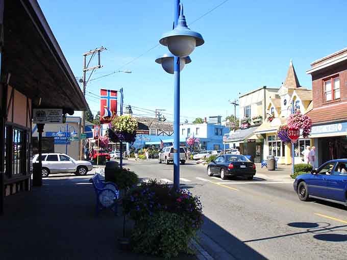 Norwegian flags flutter above flower baskets while that distinctive blue lamppost stands guard over downtown's cheerful storefronts.