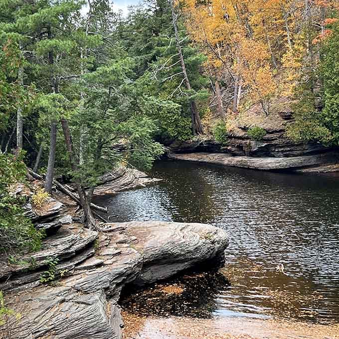The Presque Isle River knows how to make an entrance, winding through ancient rock like nature's own highway.
