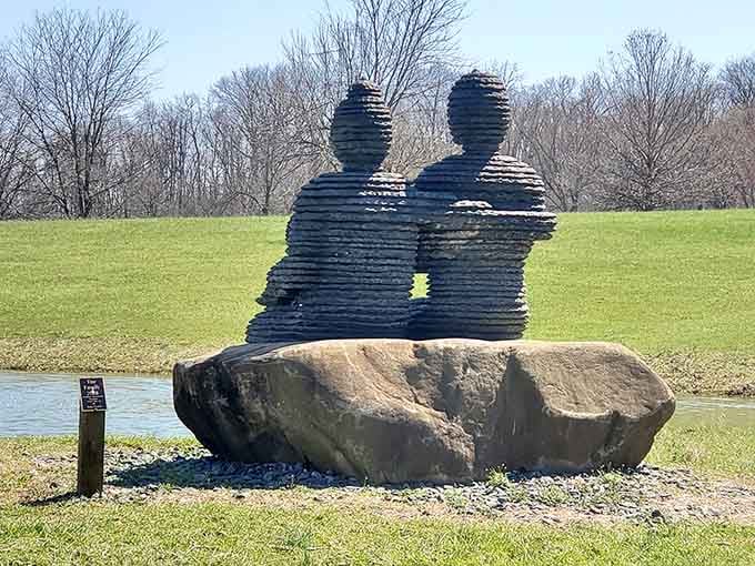 Stacked silhouettes create two figures sharing a moment by the water, proving romance works in any dimension.