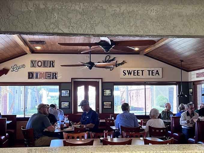 Those charming wall signs and cozy booths create the perfect atmosphere where neighbors become friends over coffee and conversation.