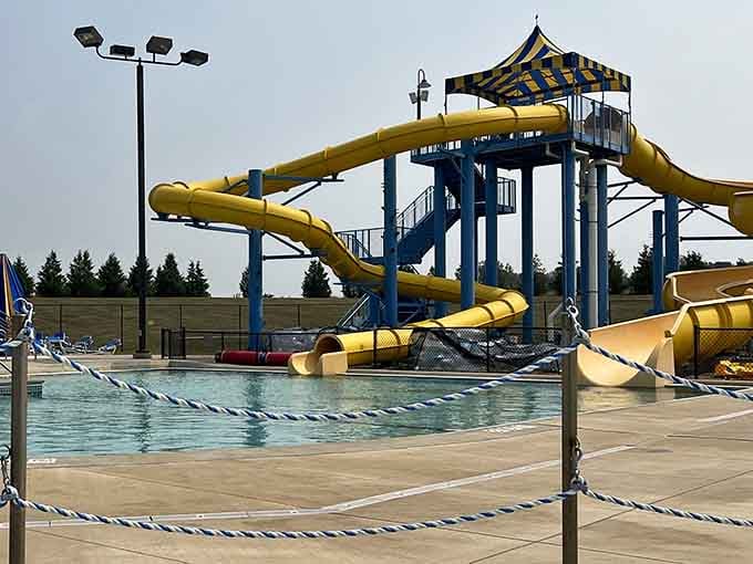 The slide tower stands ready like a colorful lighthouse guiding you toward the best summer ever.