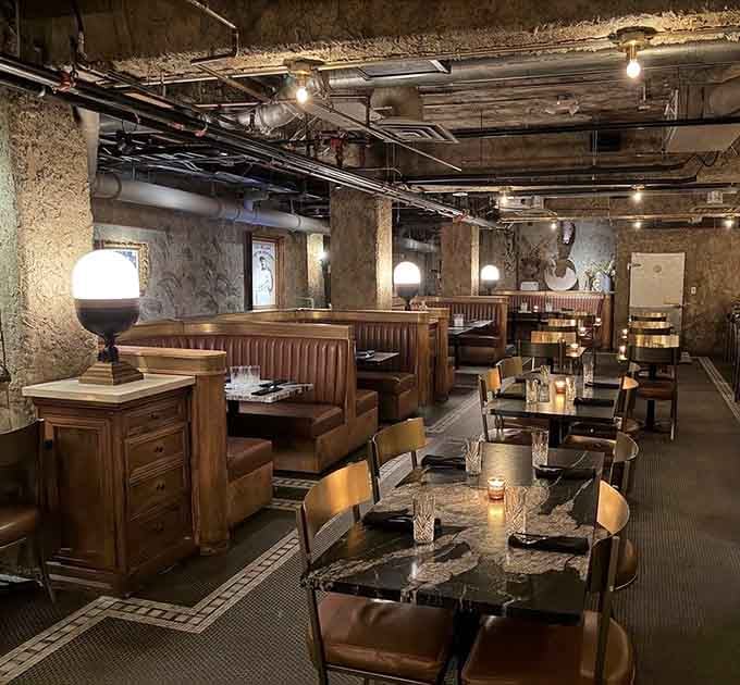 This underground dining room proves that basements can be sophisticated when exposed brick meets candlelight ambiance.