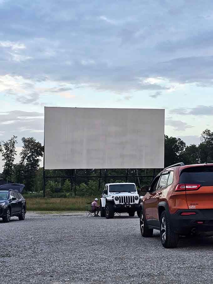 That massive white canvas stands ready to transport hundreds of moviegoers into cinematic adventures under the stars tonight.