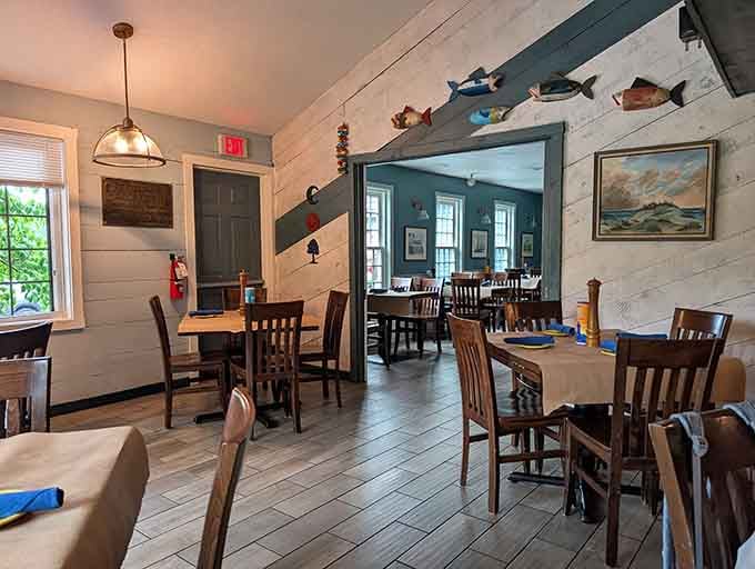 White walls, wooden fish, and nautical touches create coastal vibes without the sandy shoes required.