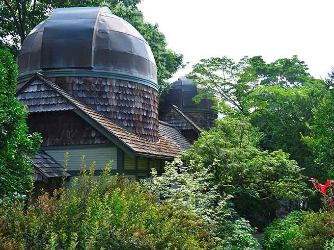That distinctive domed observatory peeks through summer greenery like a secret waiting to be discovered by wanderers.