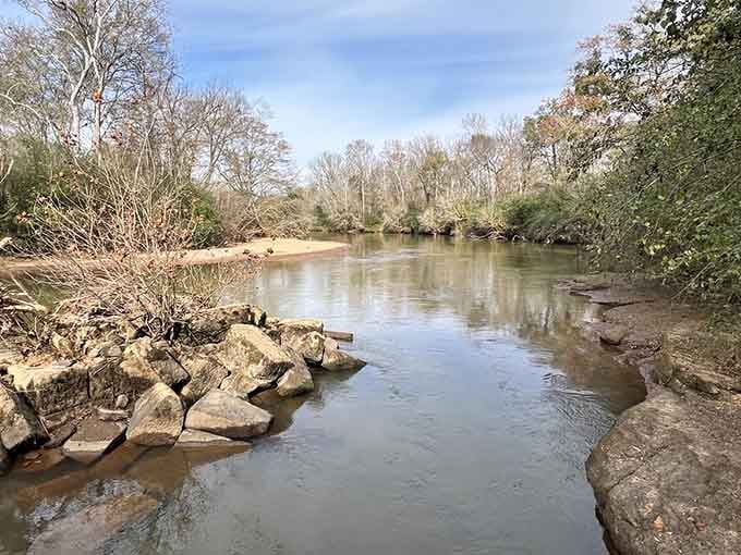 The Oconee River flows peacefully past Scull Shoals, completely unaware it once powered an entire industrial town into existence.