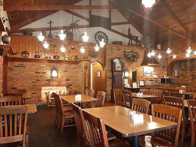 Wood beams, brick walls, and wagon wheel chandeliers create the coziest dining room this side of your favorite aunt's house.
