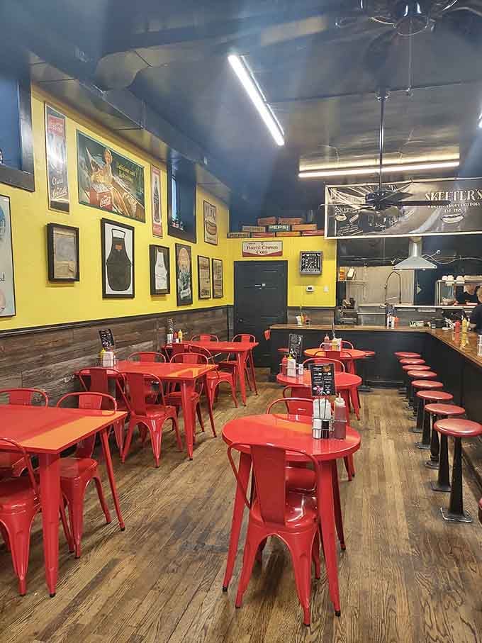 Red chairs pop against yellow walls like a perfectly dressed hot dog, creating an atmosphere that's both energetic and inviting.