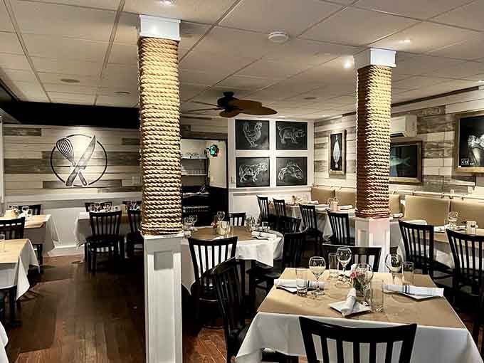 Rope-wrapped columns and crisp linens create an atmosphere where casual meets classy, like wearing your good jeans to dinner.