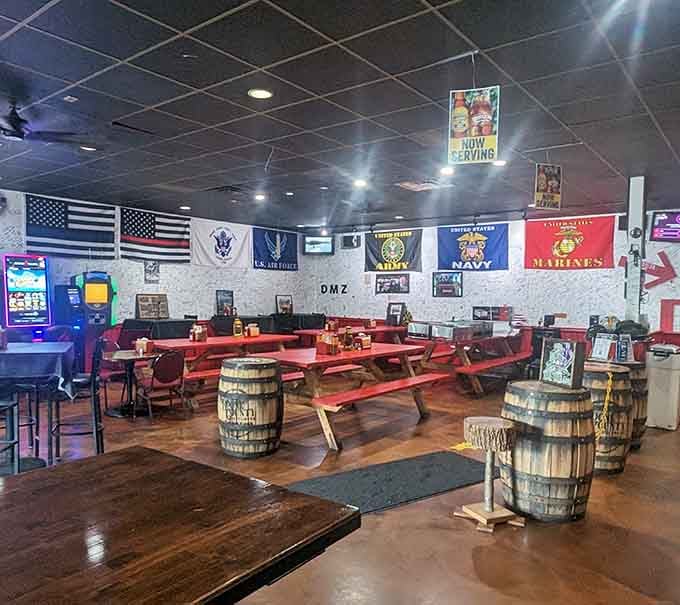 Red picnic tables and service flags create an atmosphere where patriotism meets pulled pork perfection.