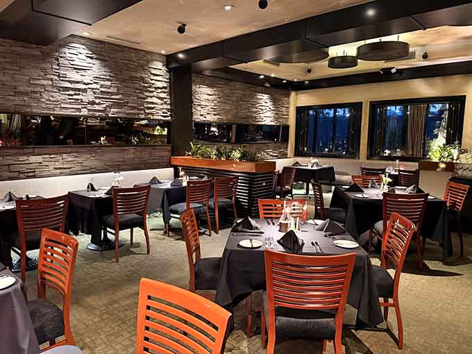 Stone walls and warm lighting create an intimate atmosphere that whispers "special occasion" without shouting pretension.