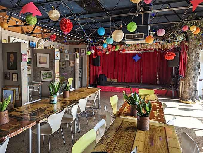 Paper lanterns float overhead like a perpetual celebration, while that red velvet stage promises entertainment beyond your morning espresso.