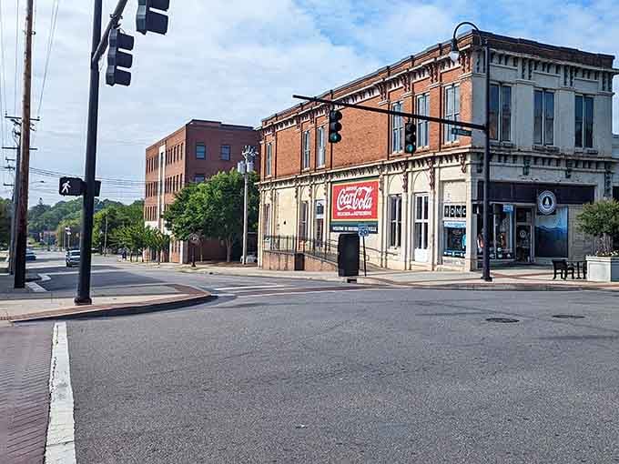That vintage Coca-Cola sign whispers stories from decades past while the brick buildings stand proud like they've got nothing to prove.