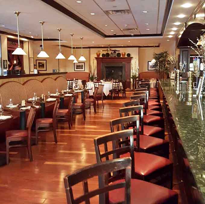 Warm wood floors, pendant lighting, and that gorgeous granite bar create the kind of upscale comfort you actually want to linger in.