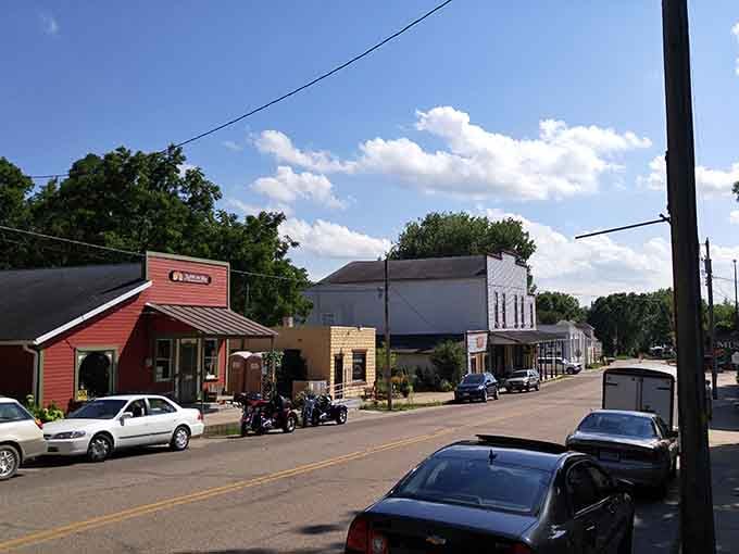 Those puffy clouds floating above the storefronts look like they were ordered special from the scenic backdrop department.