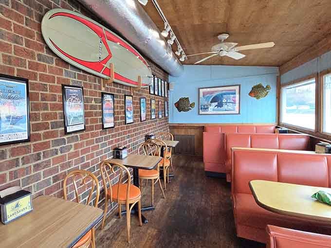 Coral booths and exposed brick create the kind of cozy atmosphere where sandwiches taste even better.
