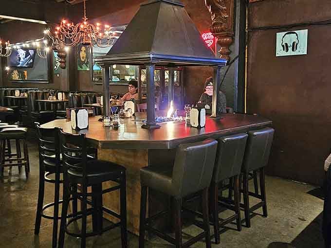 Fireplace tables and chandeliers create an atmosphere where pizza night becomes an actual event worth remembering fondly.