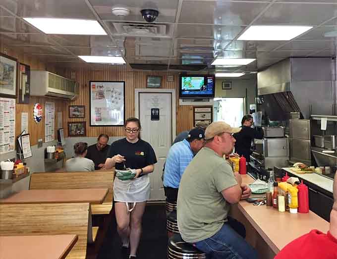 Classic counter seating and wood-paneled walls create the kind of timeless diner atmosphere where good food matters more than decor.