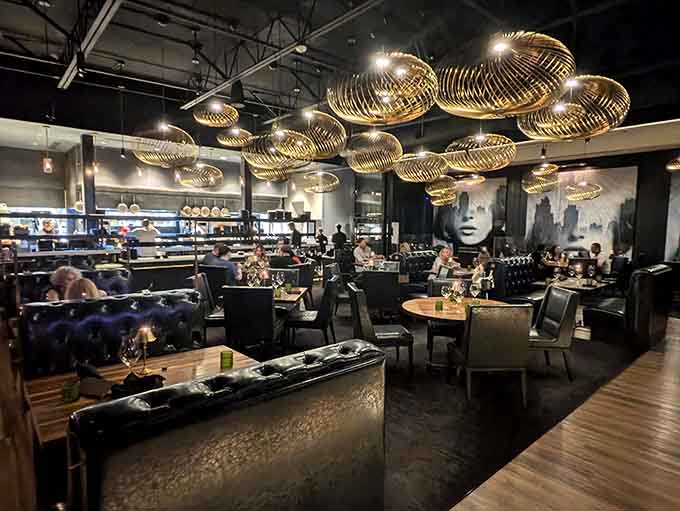 Those golden light fixtures floating overhead look like something from a modern art museum that decided to moonlight as a restaurant.