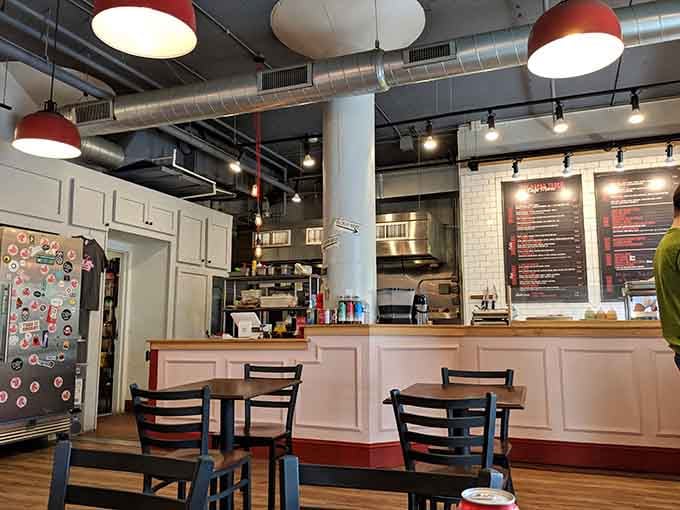 Industrial chic meets breakfast comfort with pendant lights that look like they're celebrating bacon in red and white glory.