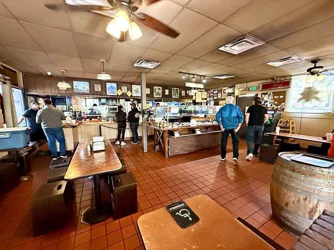 Inside, ceiling fans spin lazily above tables where burger dreams come true on blue-patterned plates.