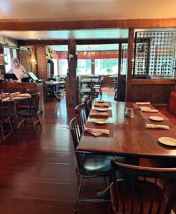 Inside, exposed beams and warm wood create the kind of timeless atmosphere where every meal feels like a special occasion.