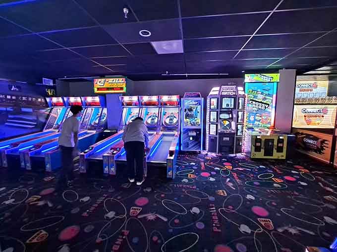 Skee-ball lanes beckon under moody lighting, ready to test your aim and humble your overconfidence immediately.