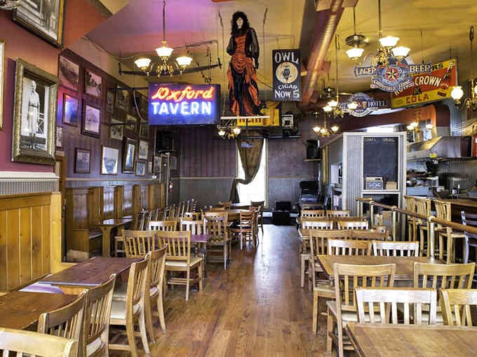 Step inside where vintage treasures hang overhead and history whispers from every corner of this atmospheric dining room.
