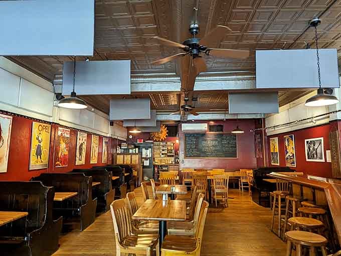 Vintage posters and warm wood create an atmosphere that feels like your coolest uncle's favorite hangout spot.