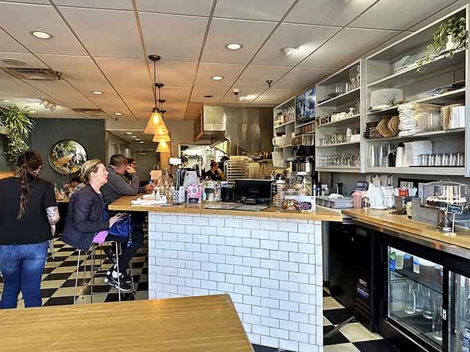 White subway tiles and warm lighting create the perfect backdrop for watching breakfast magic happen right before your eyes.