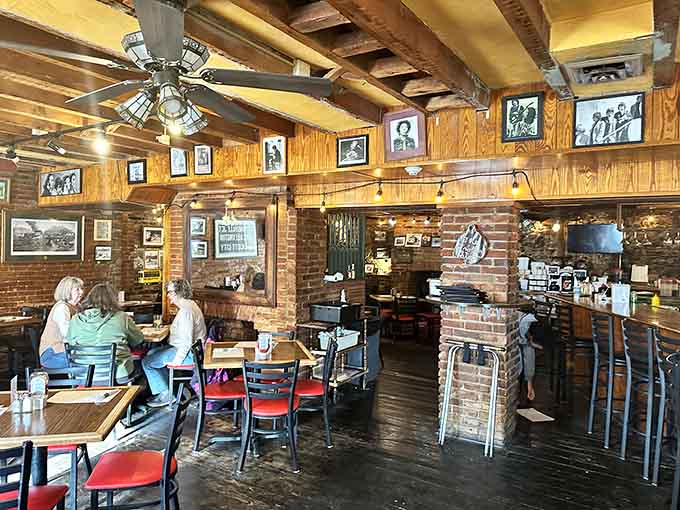 Exposed beams, brick walls, and vintage photos create an atmosphere that feels authentically timeless, not manufactured nostalgia.