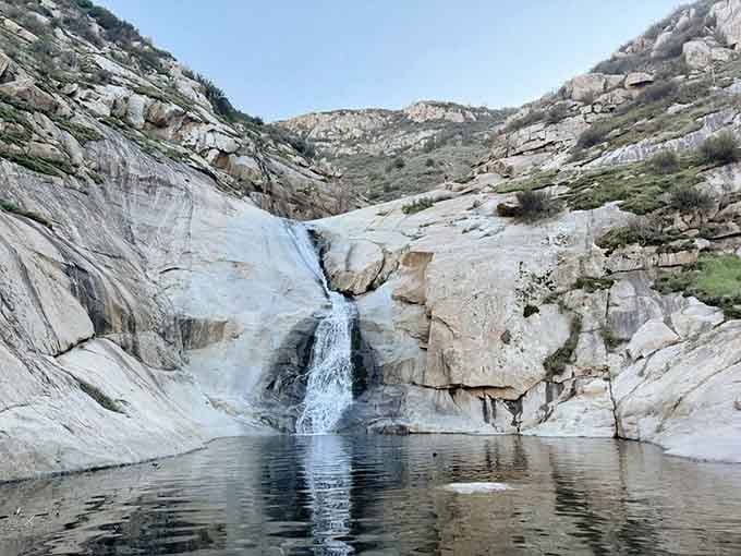 Nature's grand finale: water cascading over ancient granite into pools so blue they'll make you question reality itself.