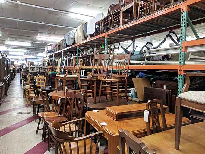 Chairs stacked like a wooden Jenga game, each one waiting to find its perfect dining room match.