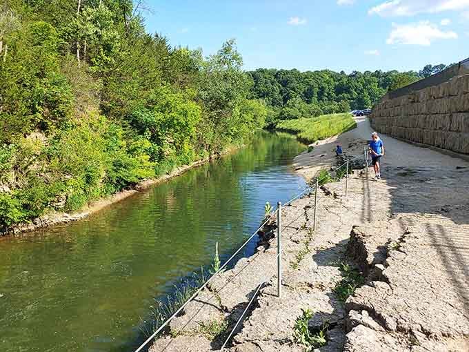 The peaceful walk along the river where fishing poles outnumber smartphones, just like the good old days.