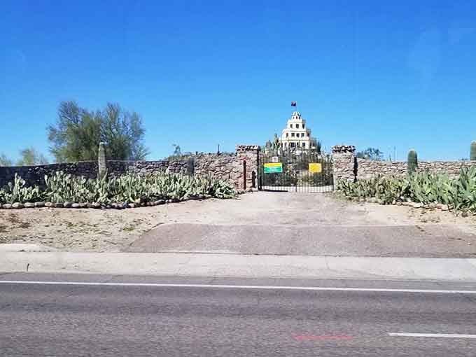 The entrance promises adventure, flanked by prickly pears that have been standing guard longer than most of us.