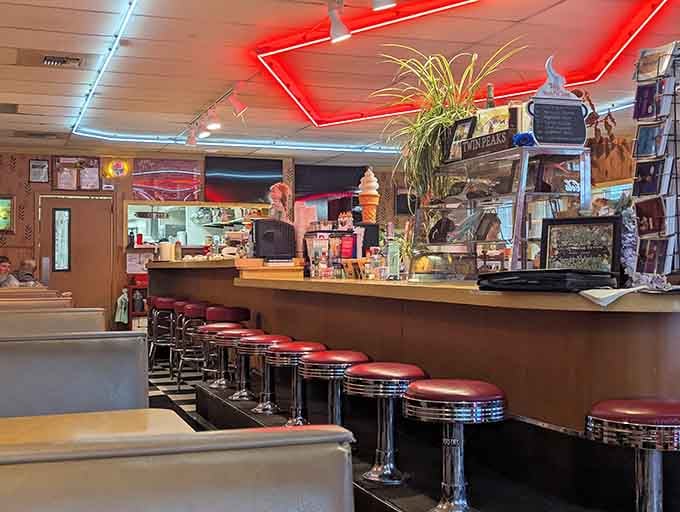 Chrome stools and red neon lighting create the kind of timeless diner atmosphere your grandparents would recognize instantly.