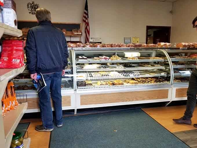 The curved display case beckons like a siren's call, filled with Polish pastries that'll ruin your diet plans.