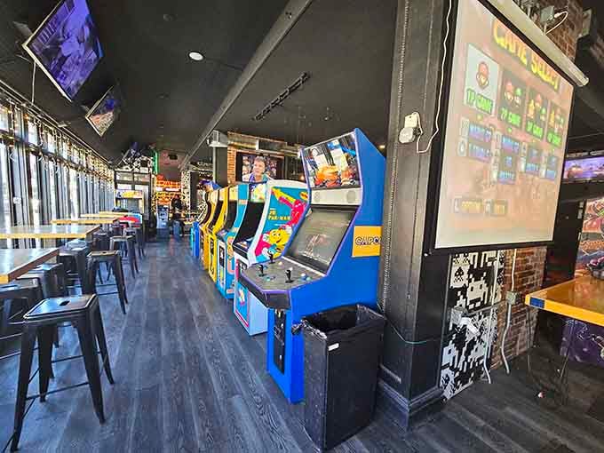 Rows of vintage arcade cabinets stand ready like old friends waiting to remind you why the '80s were actually pretty great.