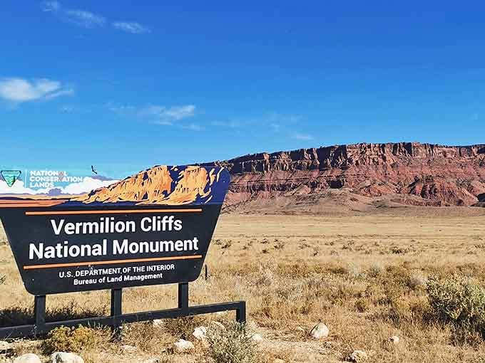 Welcome to the monument where even the sign can't compete with the jaw-dropping cliffs rising behind it.