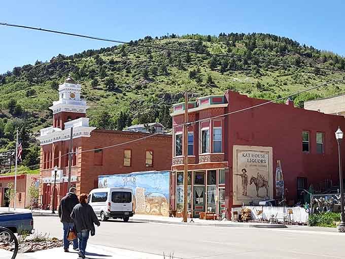 Historic storefronts stand shoulder to shoulder, their brick facades glowing in mountain sunshine like proud survivors of a hundred winters.