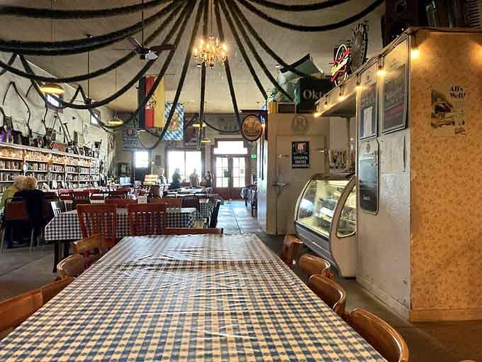 Blue and white checkered tablecloths under draped fabric ceilings create an atmosphere that's pure Bavarian charm.