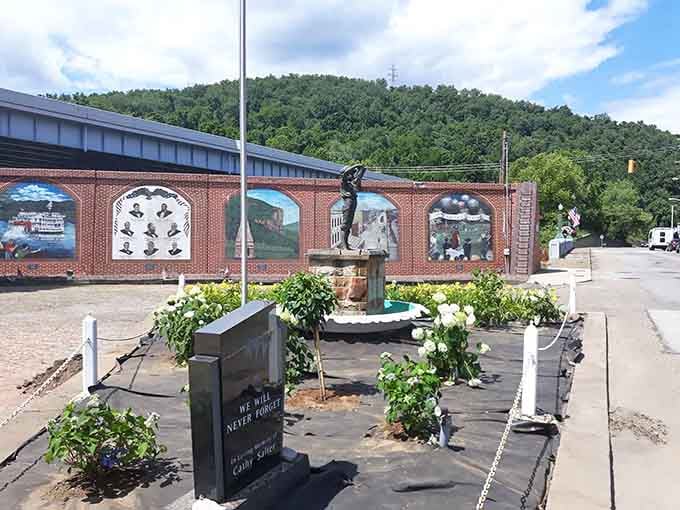 Murals celebrate local heritage along this memorial wall, where community pride costs nothing but means everything to residents.