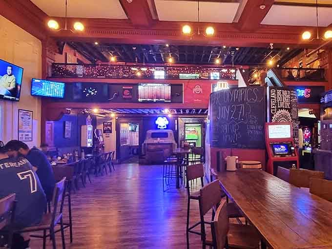 Step inside where exposed beams, warm lighting, and sports memorabilia create the perfect backdrop for serious burger consumption.